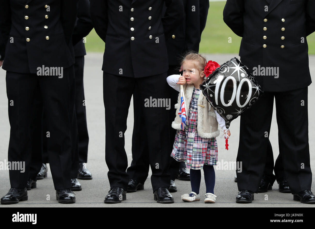 Esme Sutton, daughter of a staff member, plays with a balloon and a ...