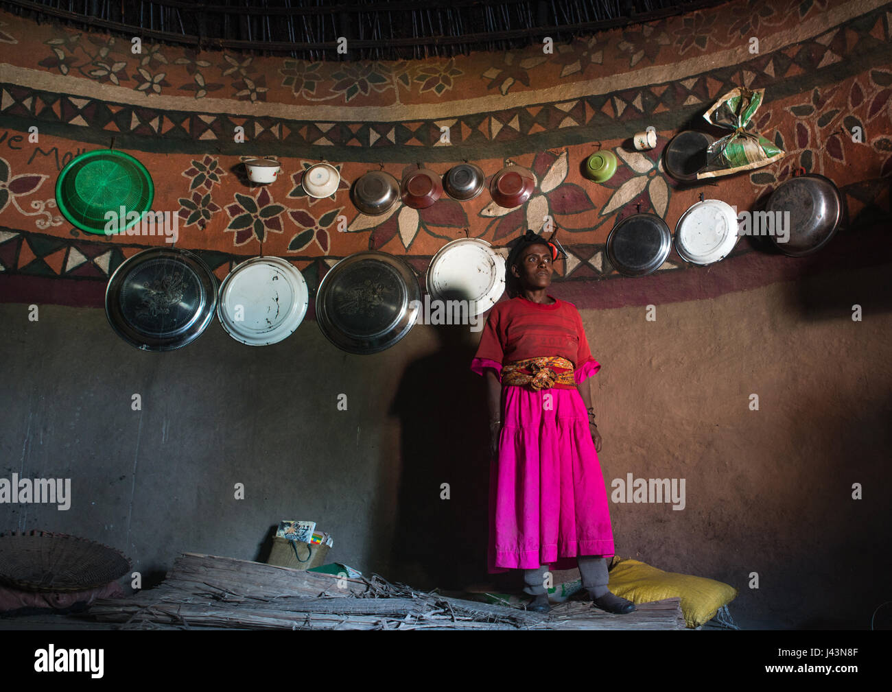 Ethiopian woman inside her traditional painted and decorated house ...