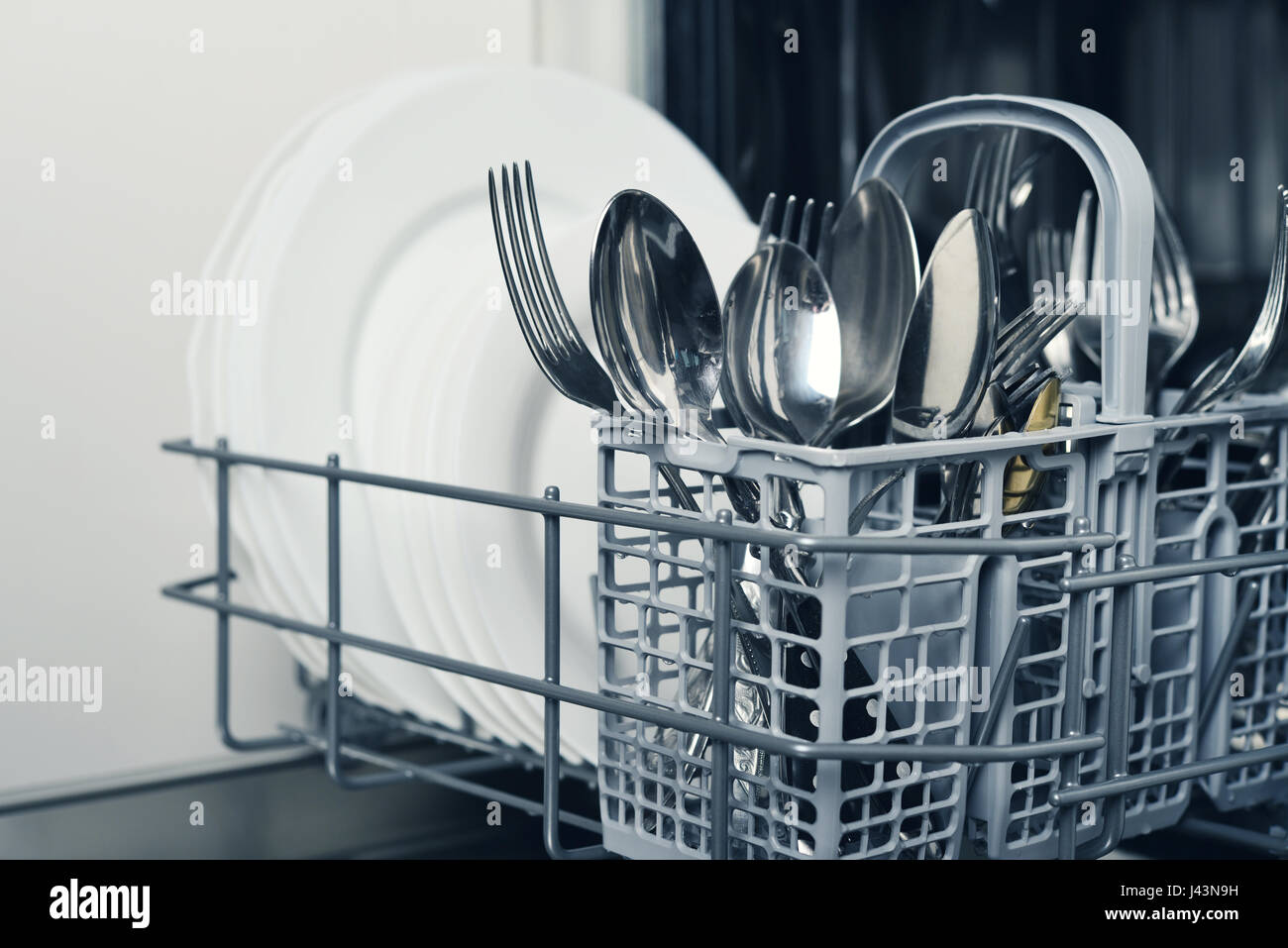 Clean cutlery and plates after washing in dishwasher machine Stock ...