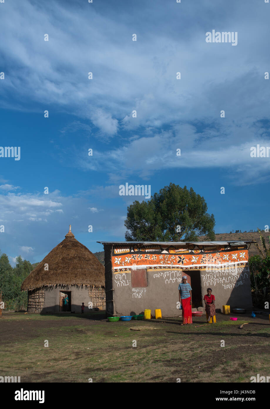 Women standing in front of their traditional painted house, Kembata ...
