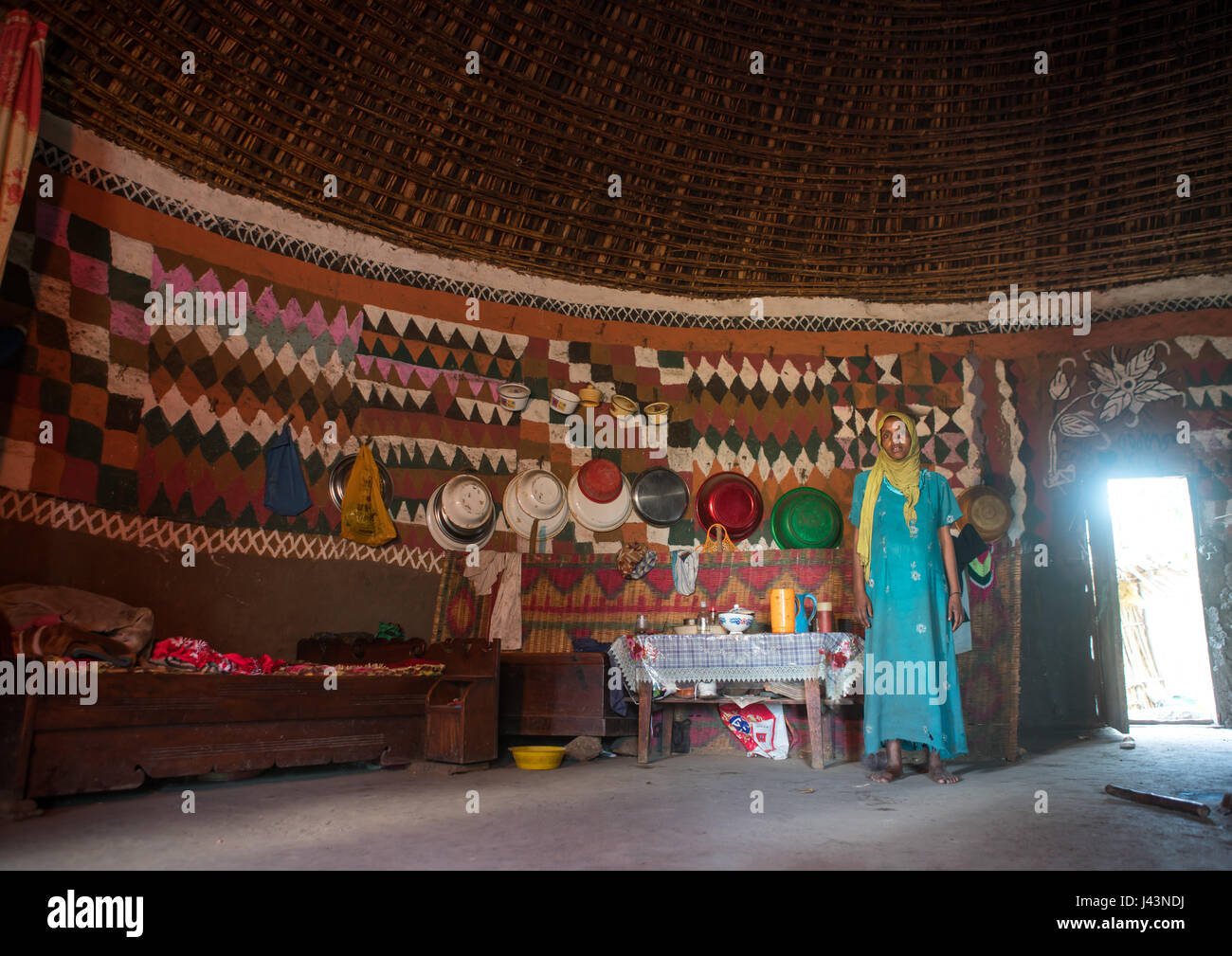 Ethiopian woman inside her traditional painted and decorated house ...