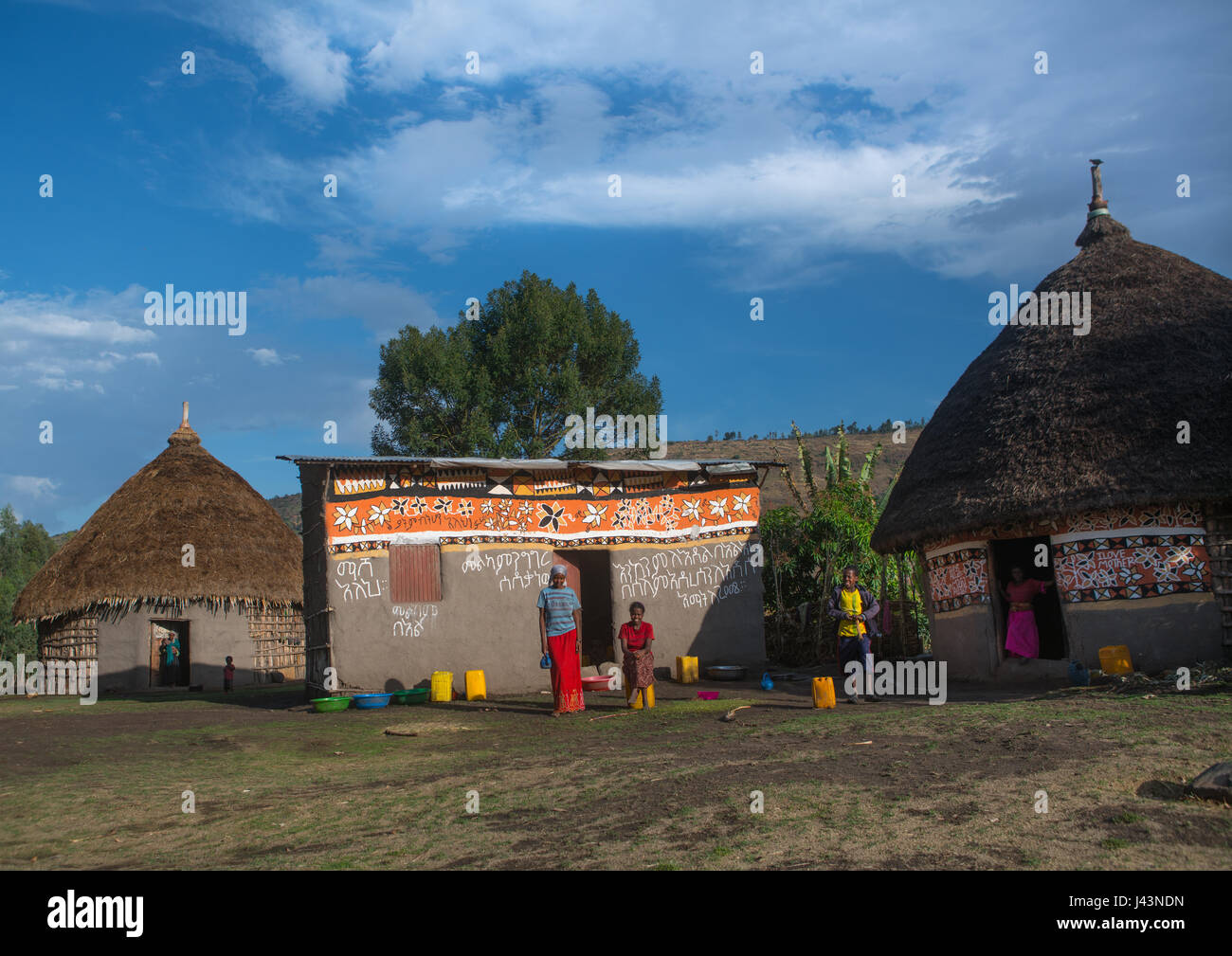 Women standing in front of their traditional painted house, Kembata ...