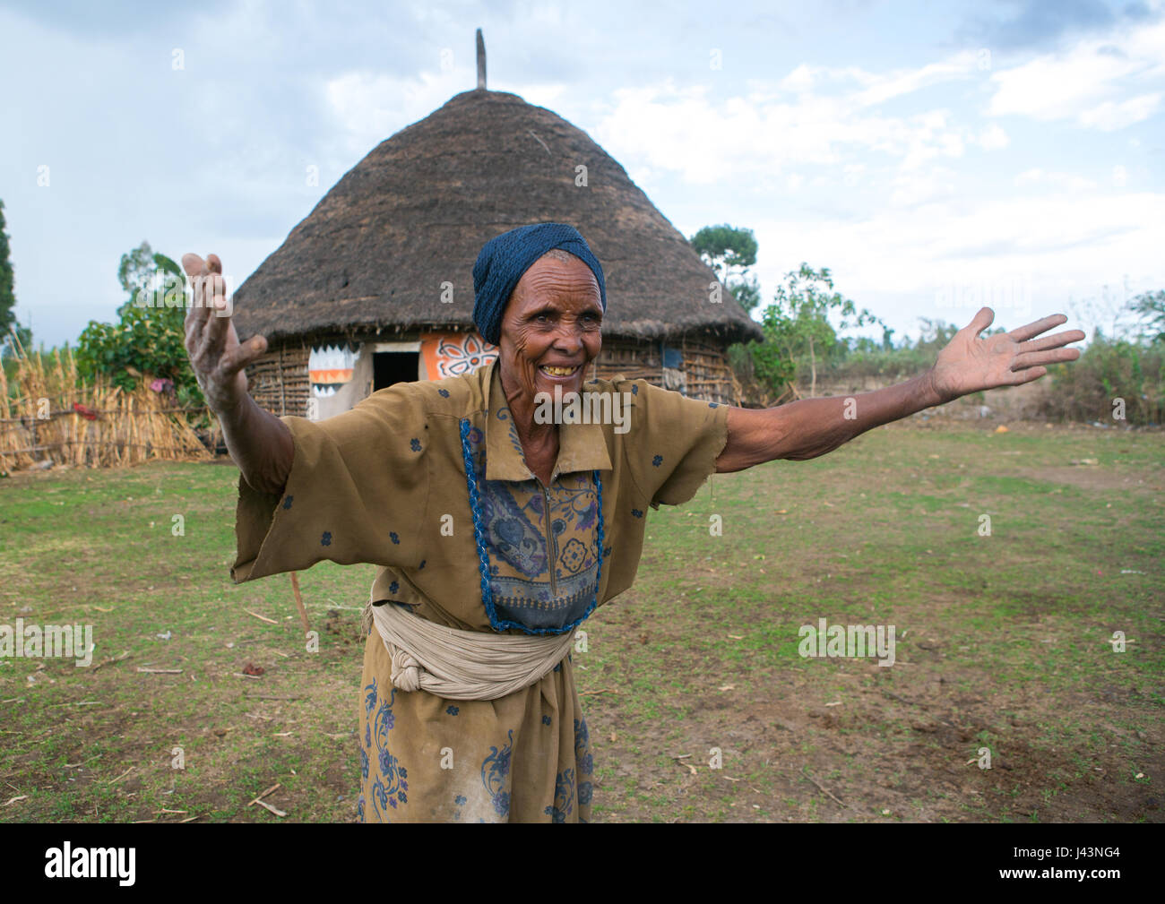 Ethiopian woman in front of her traditional painted house, Kembata ...