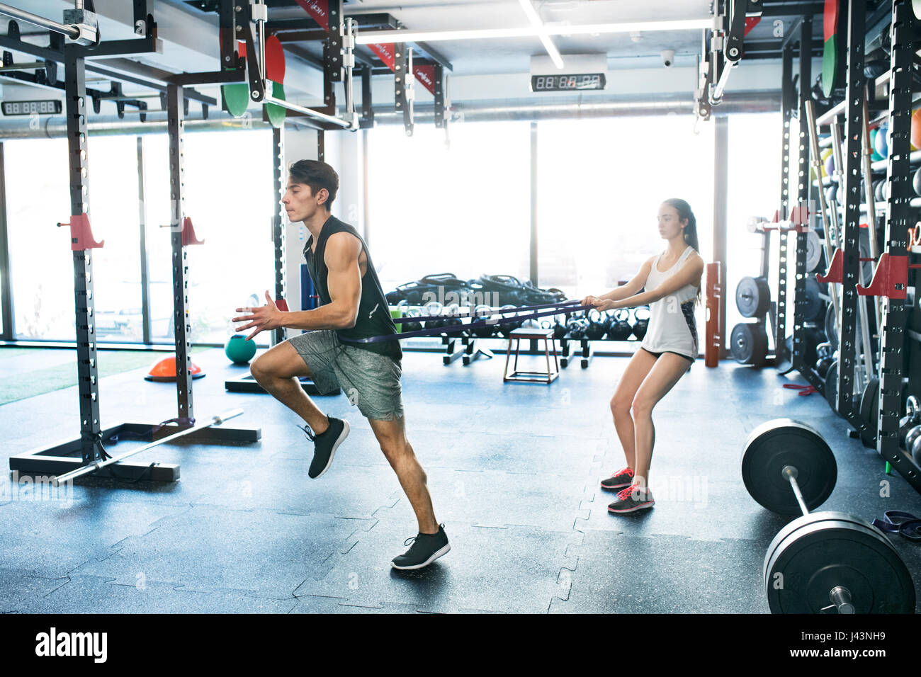 Strong man using a resistance band in his exercise routine Stock Photo ...