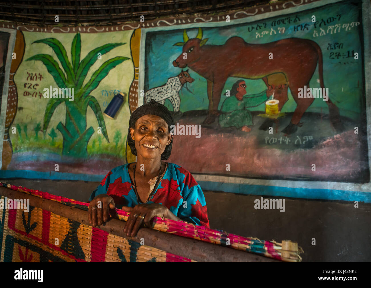 Ethiopian woman inside her traditional painted and decorated house ...