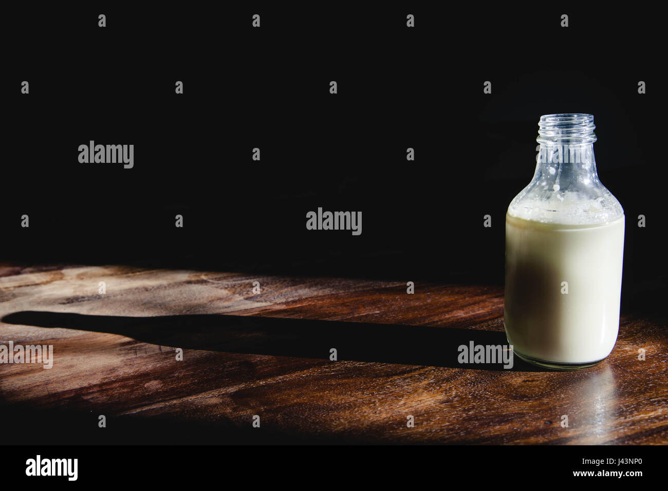 Milk in an old fashioned antique milk bottle Stock Photo - Alamy