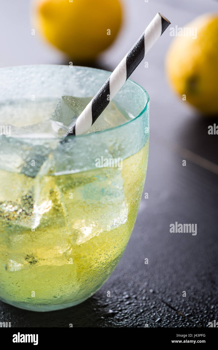 Cold Lemonade With Ice Cubes and Lemon on Dark Background Stock Photo ...