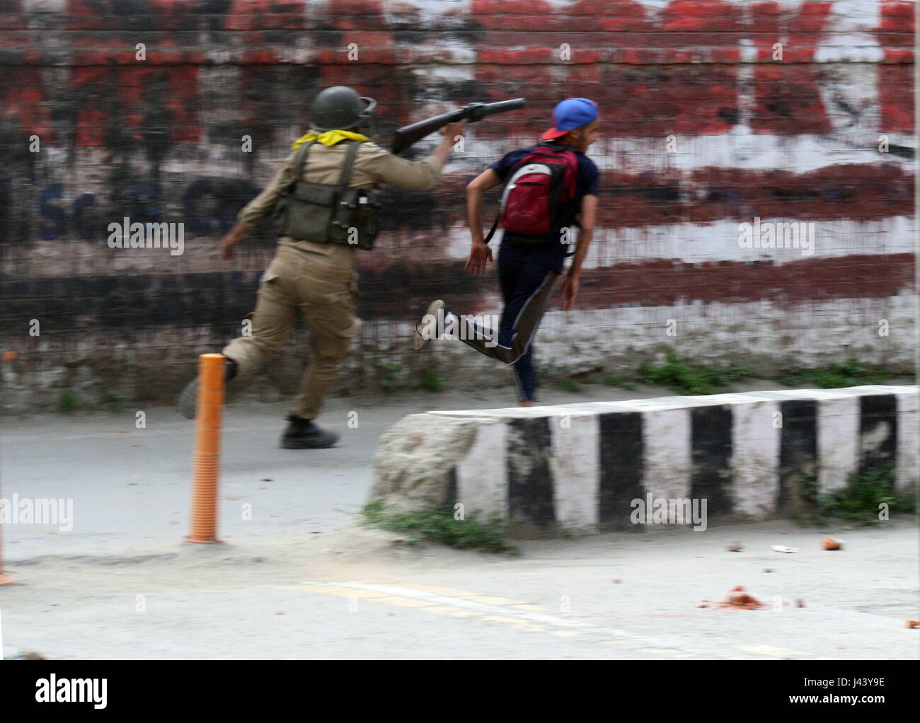 Srinagar, Kashmir. 9th May, 2017. Police chasing student during student ...