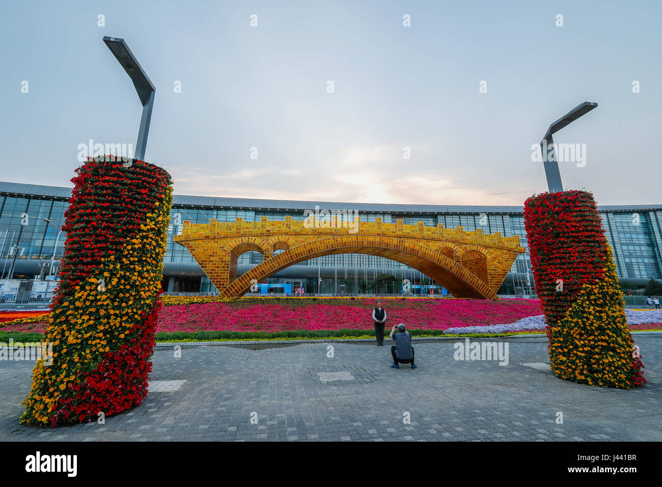 Beijing, China. 9th May, 2017. People pose for photos with the "Golden ...