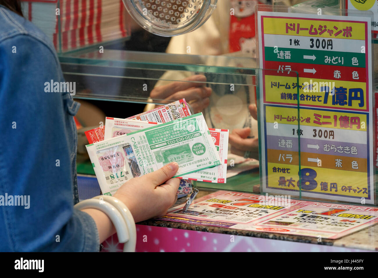 People purchase lottery tickets on the first day of sale for the annual ...