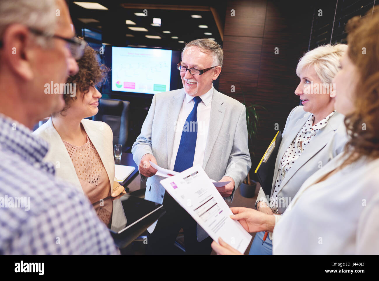 Public speaker deliberating with coworkers Stock Photo - Alamy