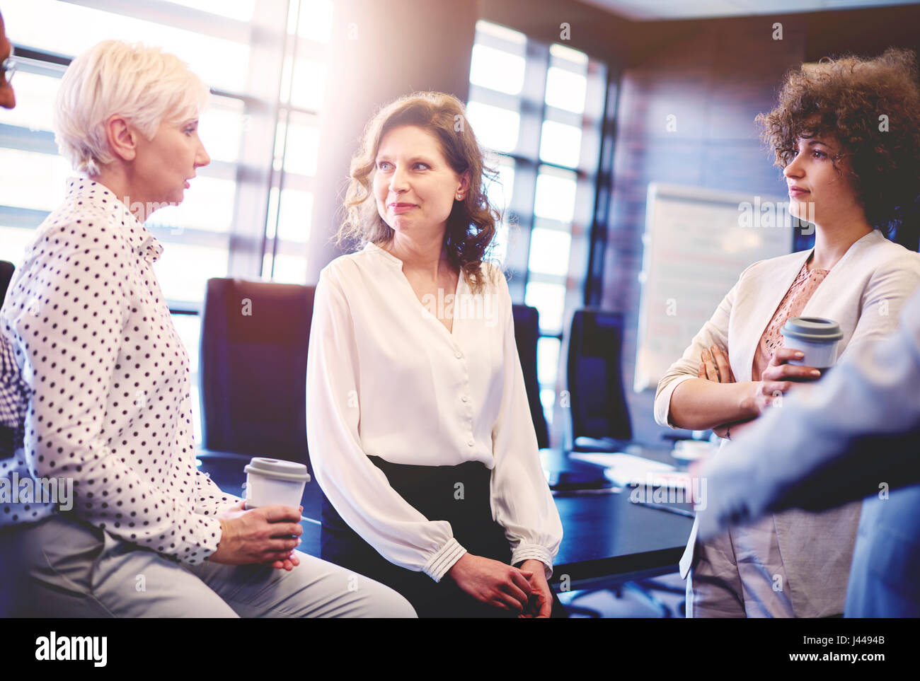 Business colleagues having a chat over coffee break Stock Photo - Alamy