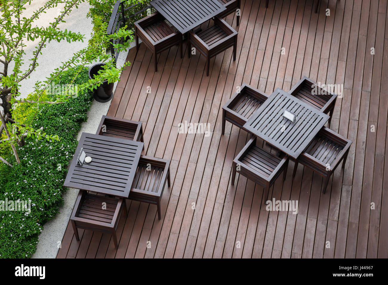 Top view of table and four chairs on living terrace at cafe Stock Photo ...