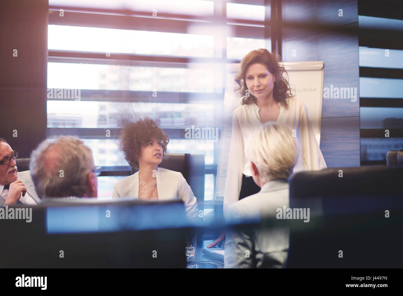 View of through the window hard working coworkers Stock Photo - Alamy