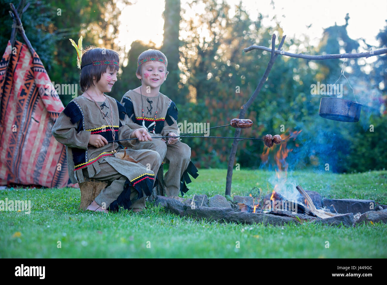 Cute portrait of native american boys with costumes, playing outdoor ...