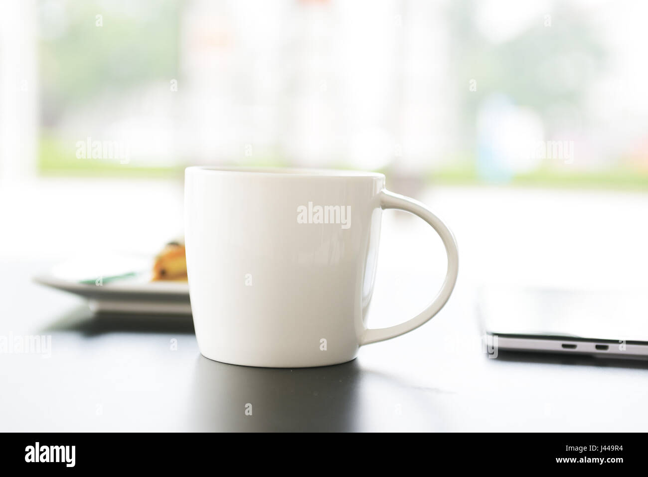 Tablets and close-ups of coffee cup on the table Stock Photo - Alamy