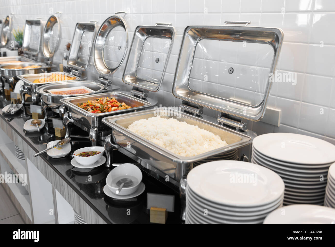 Food on buffet table with dishware Stock Photo - Alamy