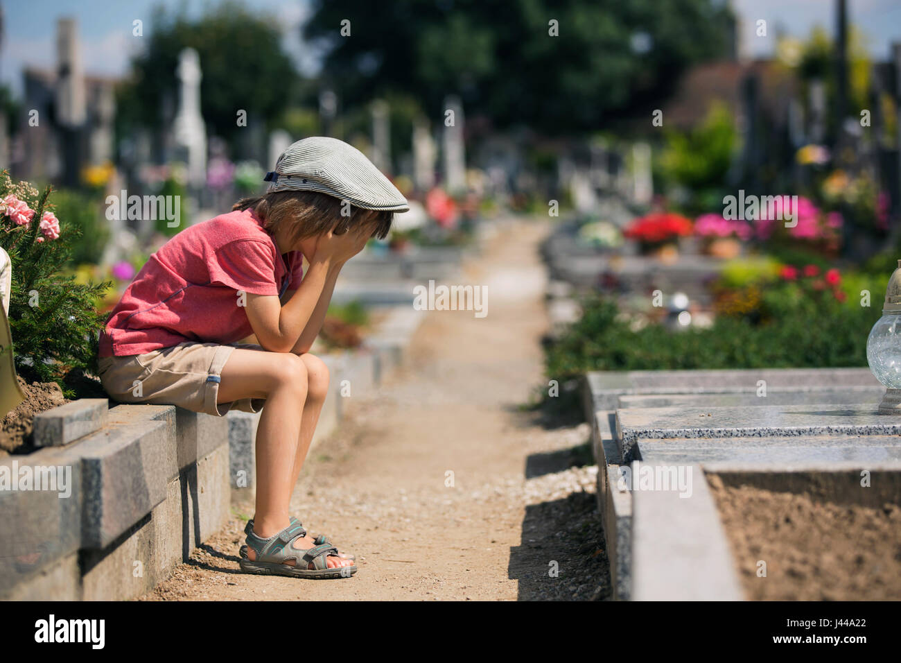 Boy sitting on grave on hi-res stock photography and images - Alamy
