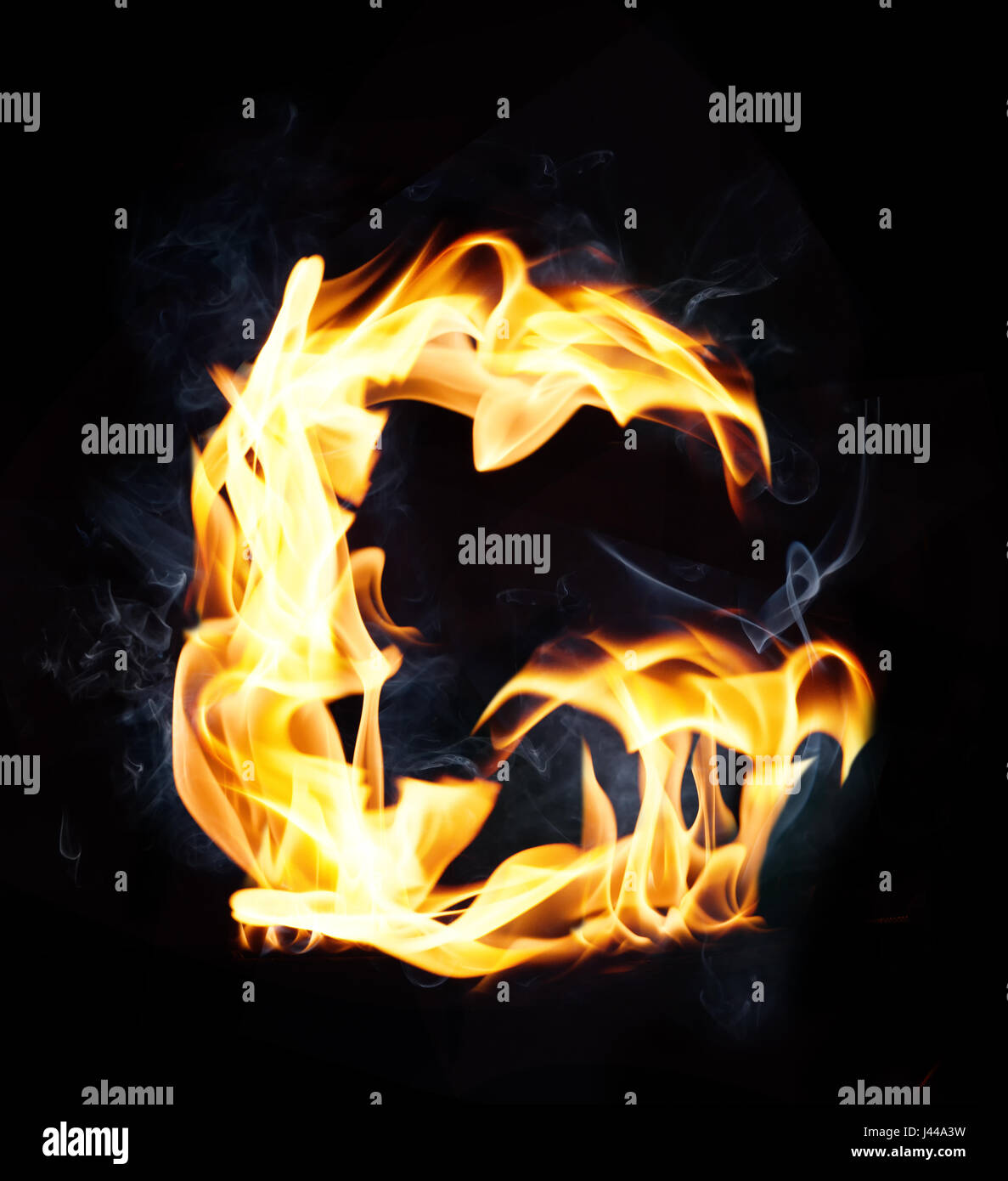 Letter G. Fire and smoke alphabet over black background Stock Photo - Alamy