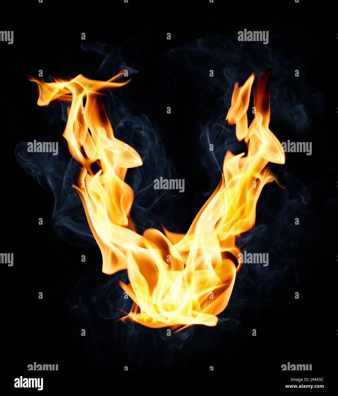 Letter V. Fire and smoke alphabet over black background Stock Photo - Alamy