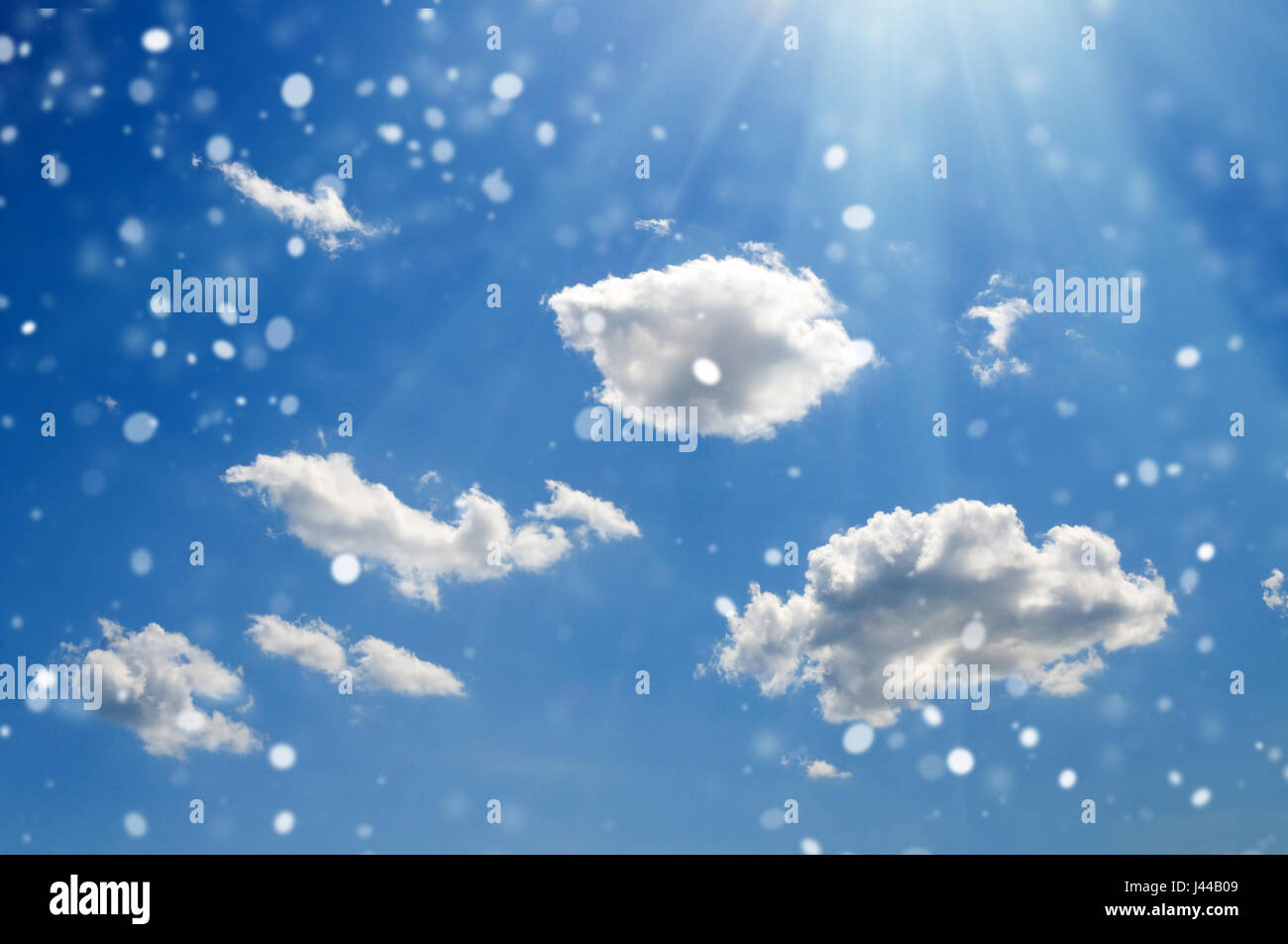 falling from white clouds snowflakes on blue sky background Stock Photo ...