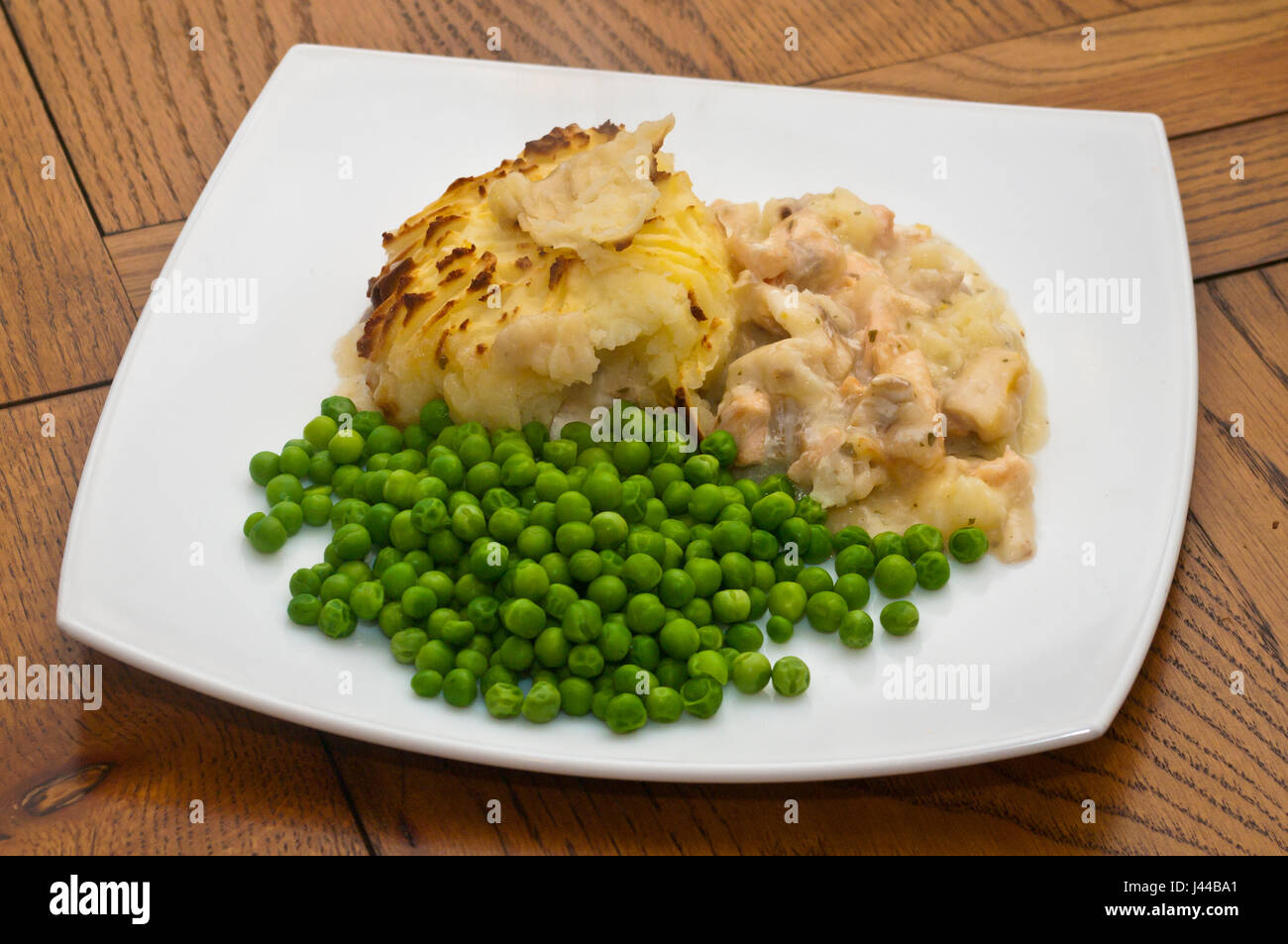 Fish Pie and Peas On A White Plate Stock Photo - Alamy