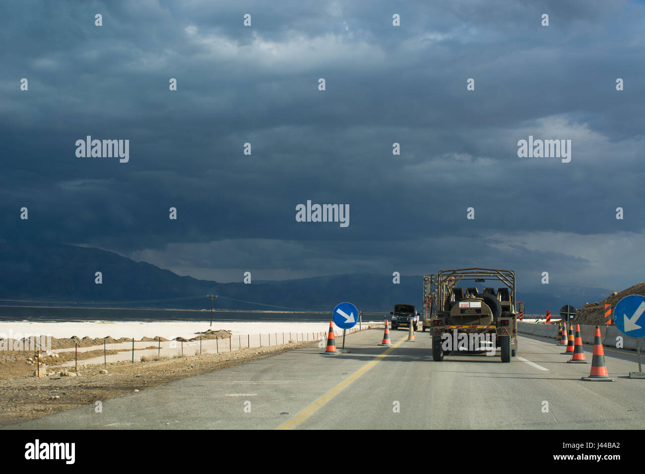 Roadwork, hard working conditions on the road, cars trying to pass ...