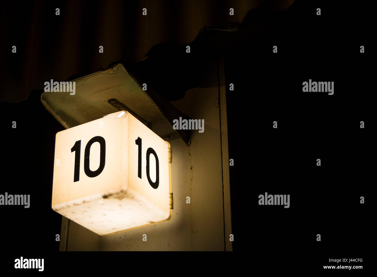 Bold number ten sign shining against large dark background Stock Photo ...