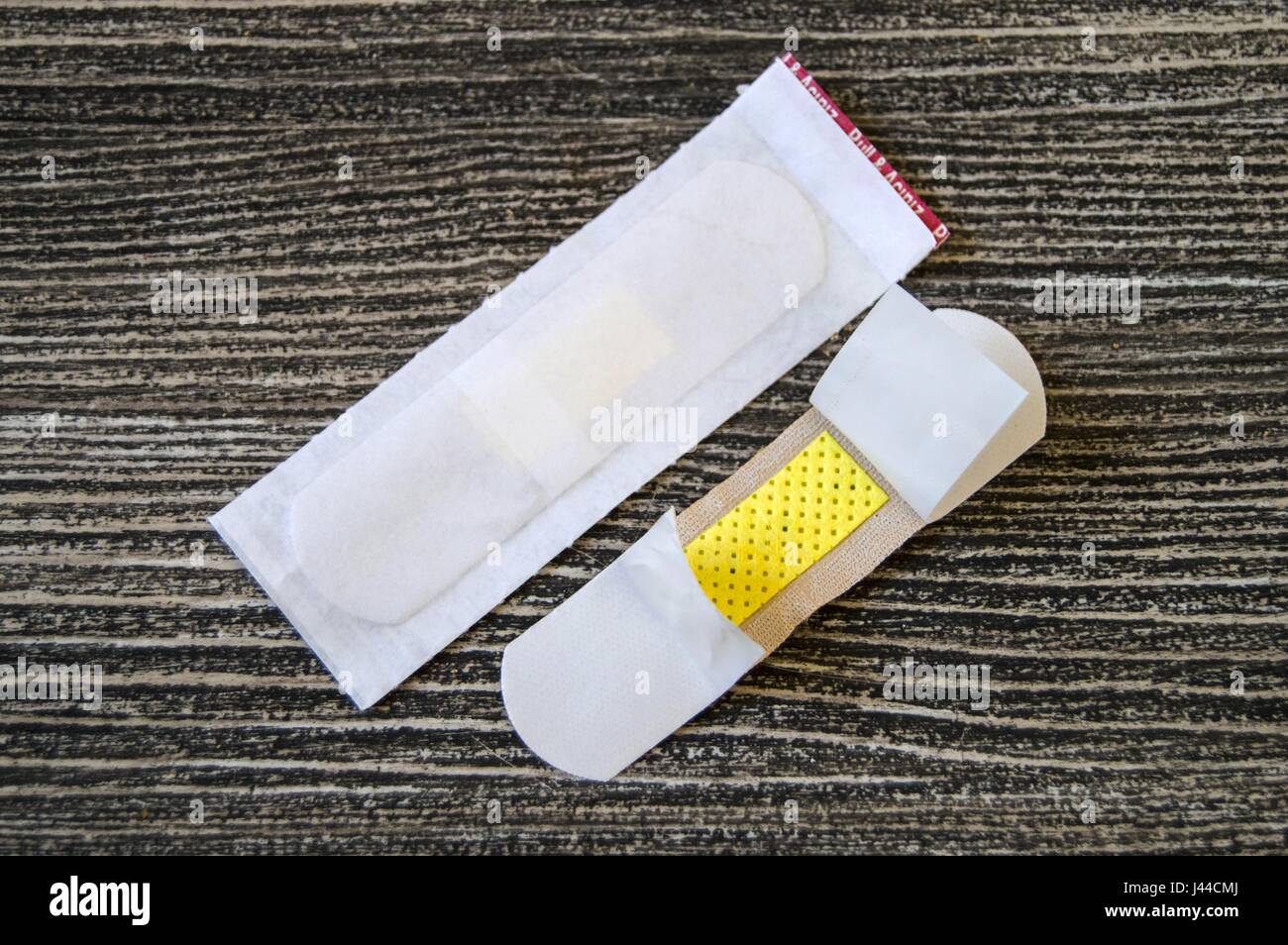 Hand cutting bandage hi-res stock photography and images - Alamy