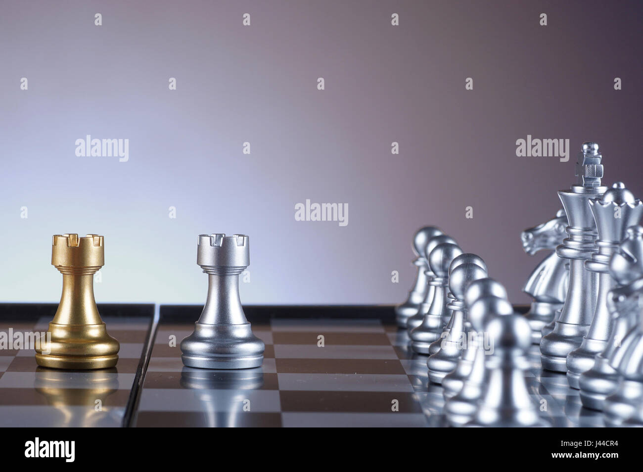 Rook silver facing golden rook chess set on gradient background ...