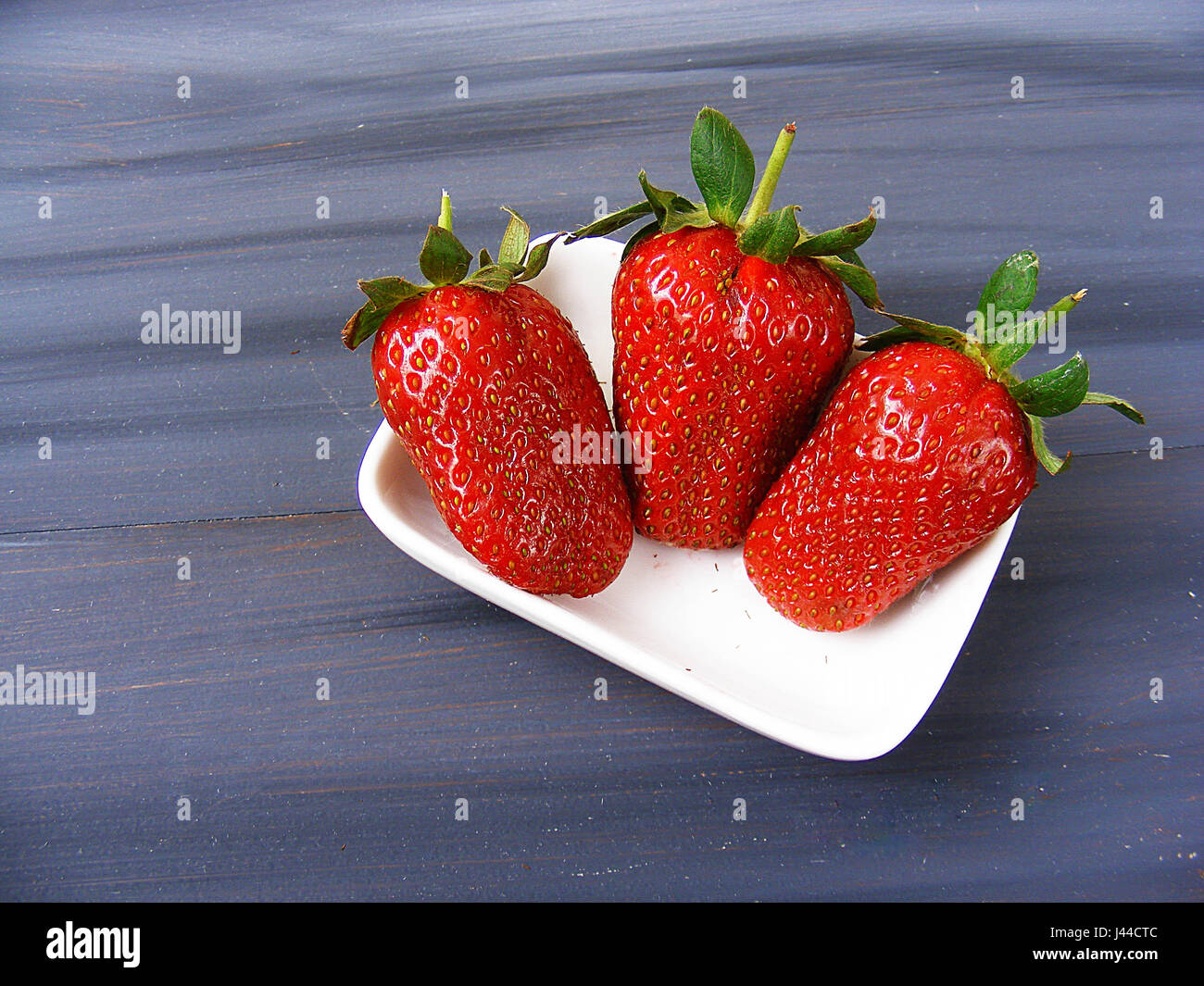 Strawberries on the rustic floor, strawberries in the plate, lovely ...