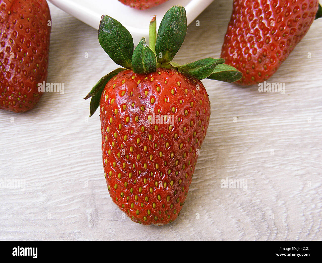Strawberries on the rustic floor, strawberries in the plate, lovely ...