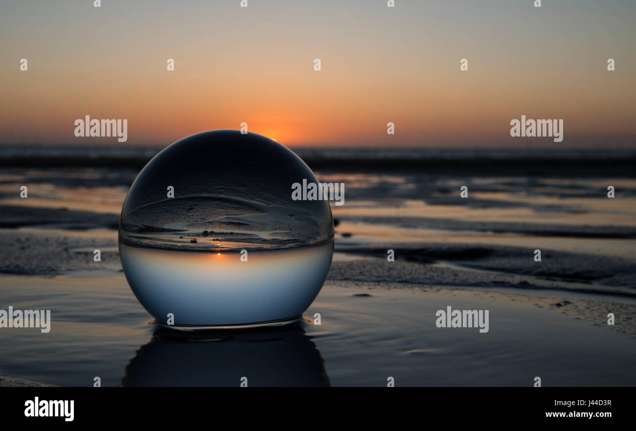 sunset on the beach captured in glass crystal sphere Stock Photo - Alamy