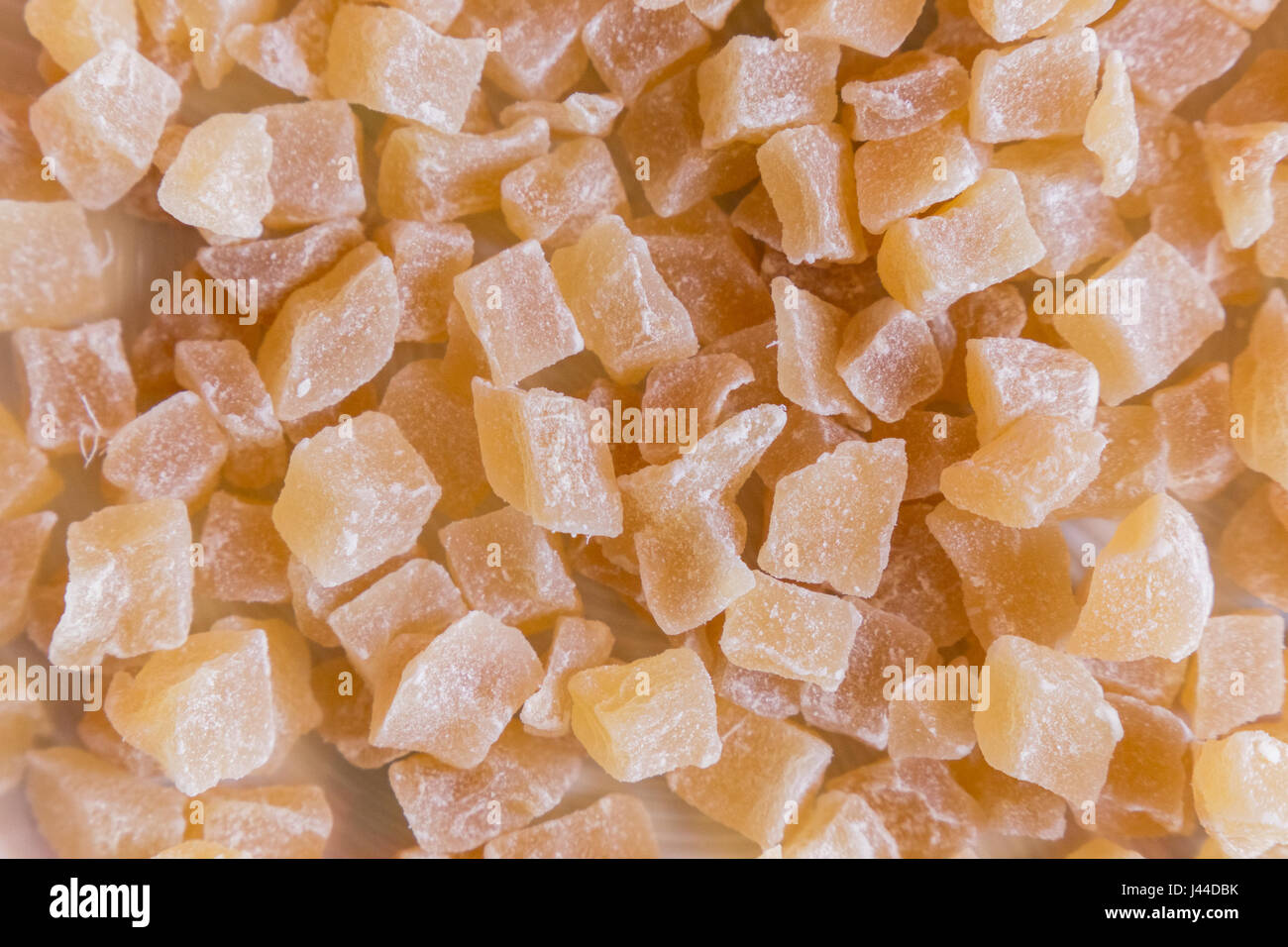 Sweet candied ginger cubes background Stock Photo - Alamy