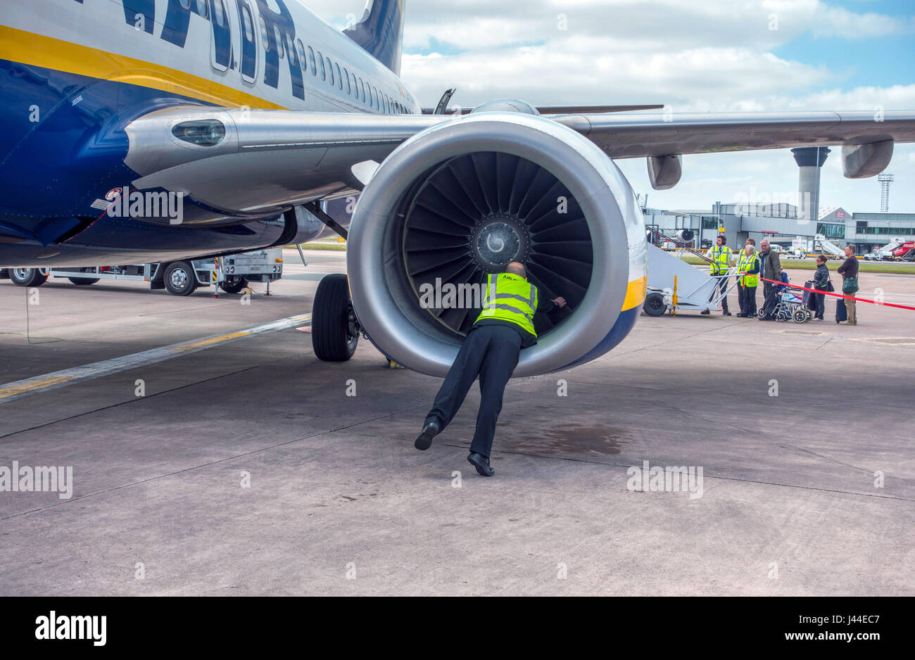 Air crew checking the engine of Ryanair Boeing 737 at Manchester ...