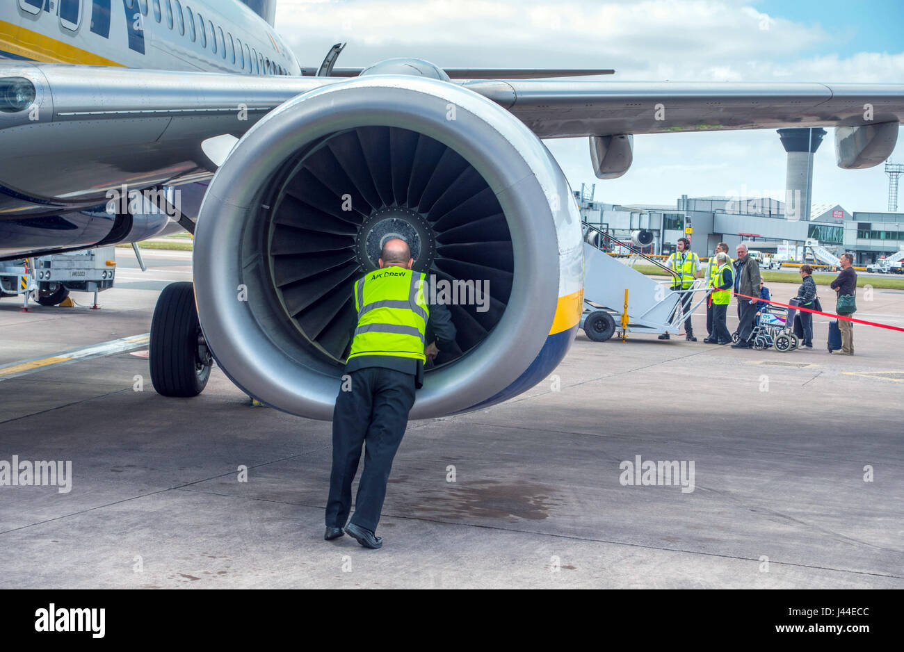 Air crew checking the engine of Ryanair Boeing 737 at Manchester Stock ...