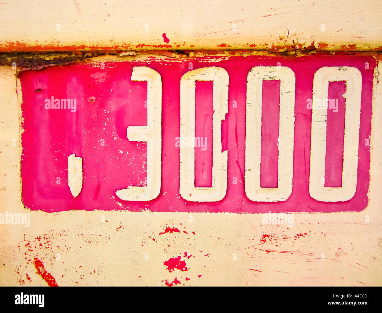 Metallic number 3000 painted yellow on a pink background Stock Photo ...
