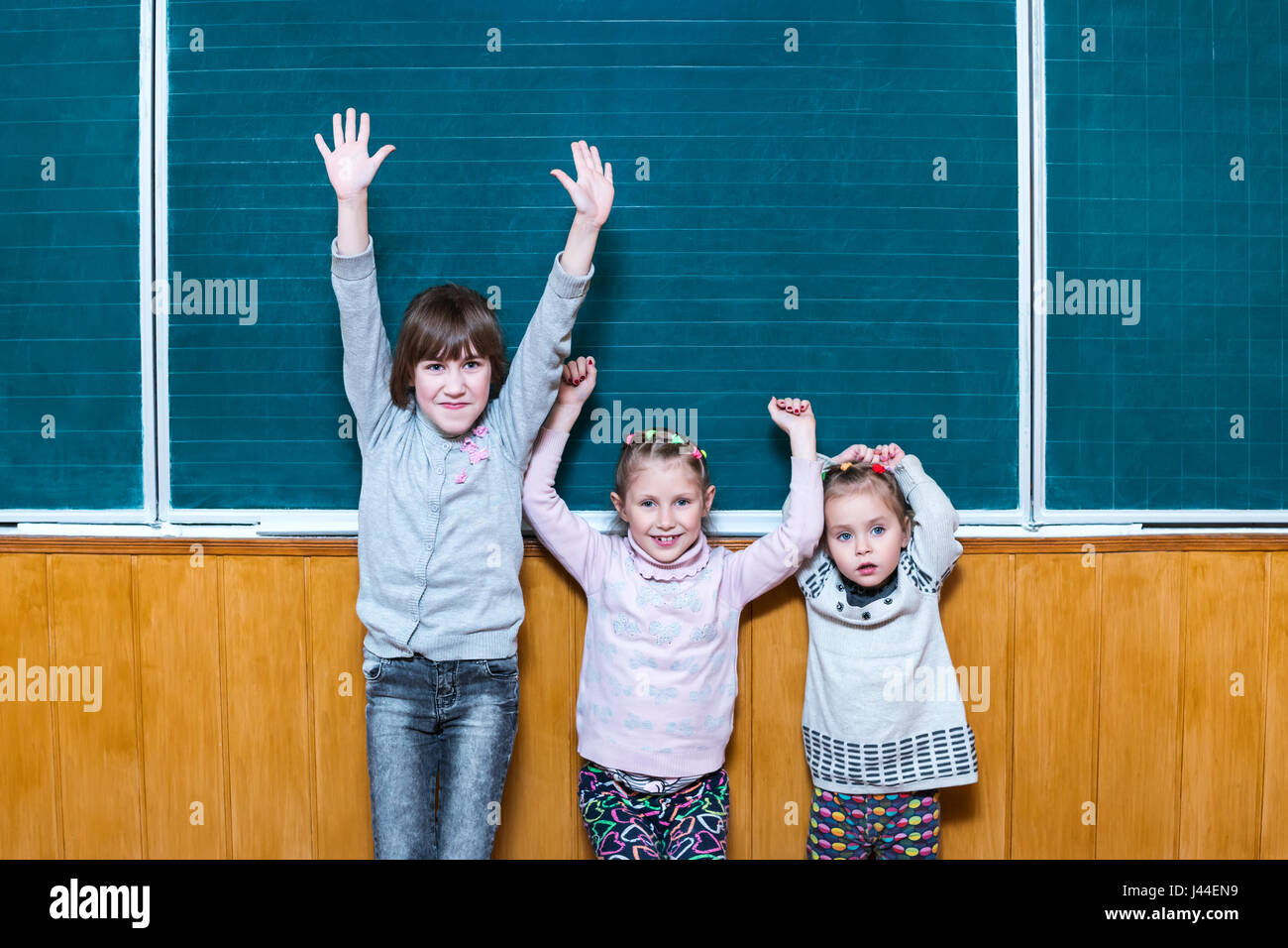 Children classroom smiling hands up hi-res stock photography and images ...