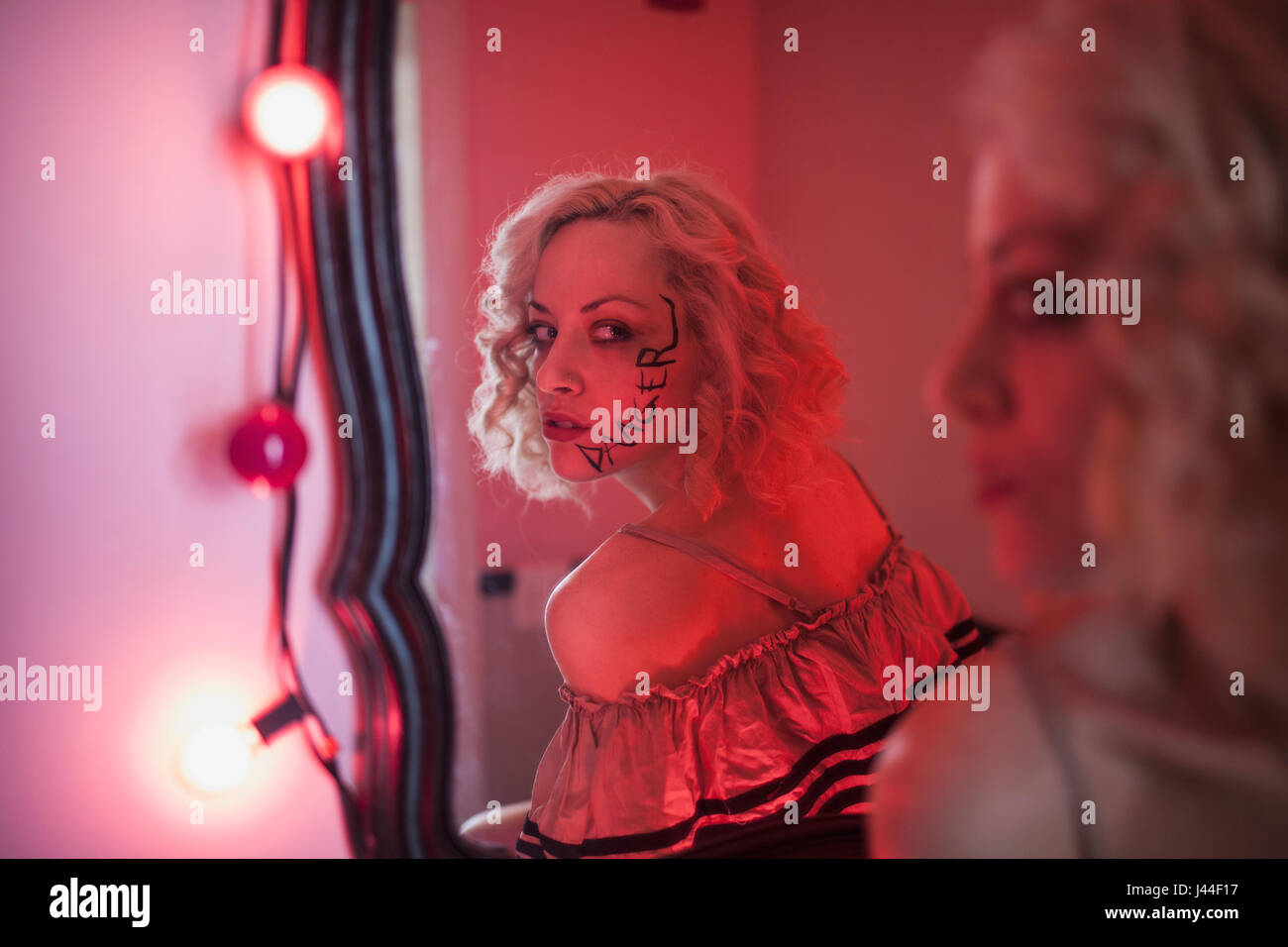 Woman looking over shoulder mirror hi-res stock photography and images ...