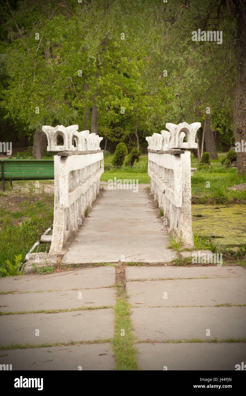 Small bridge from rocks in park Stock Photo - Alamy