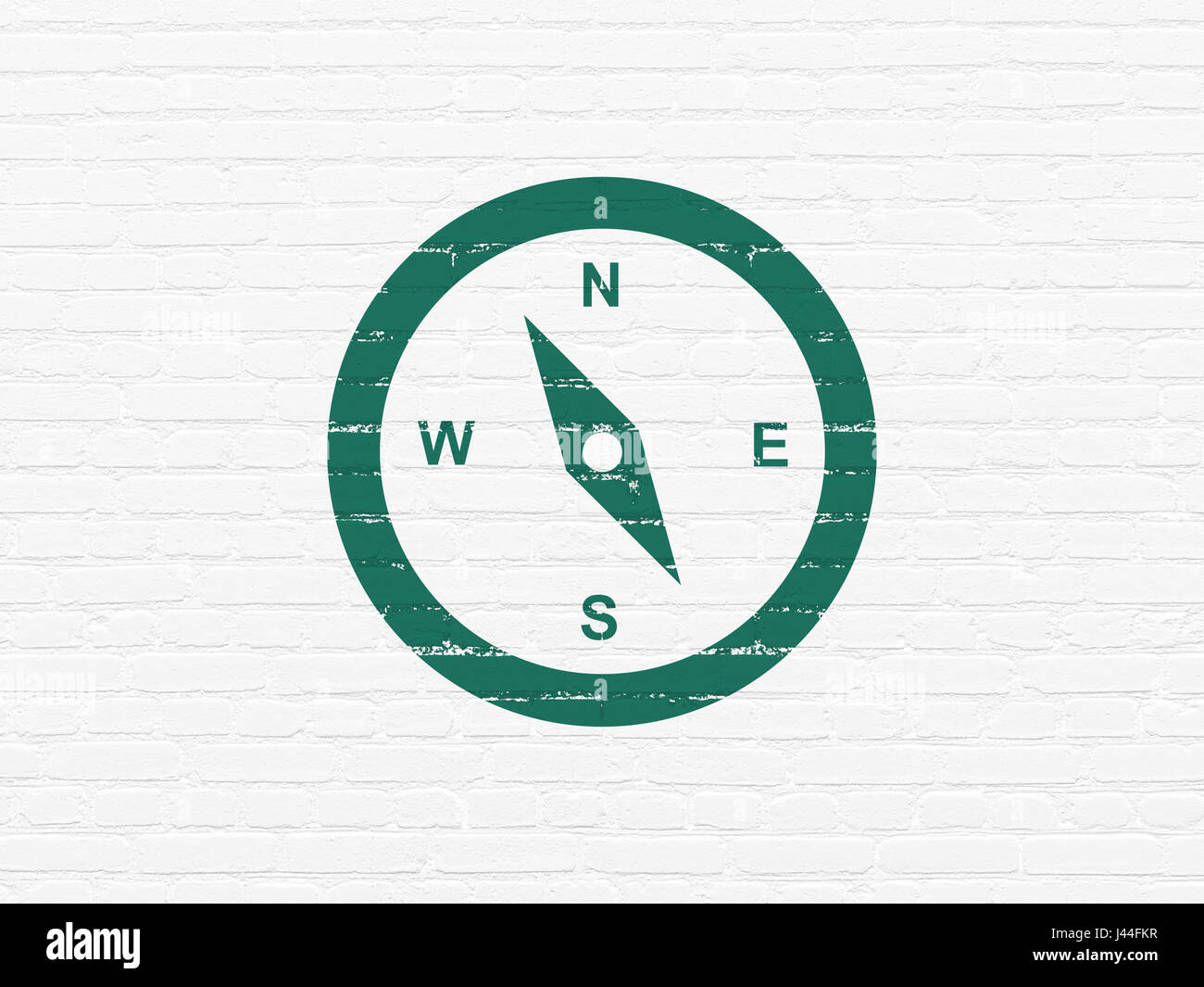 Tourism concept: Compass on wall background Stock Photo - Alamy