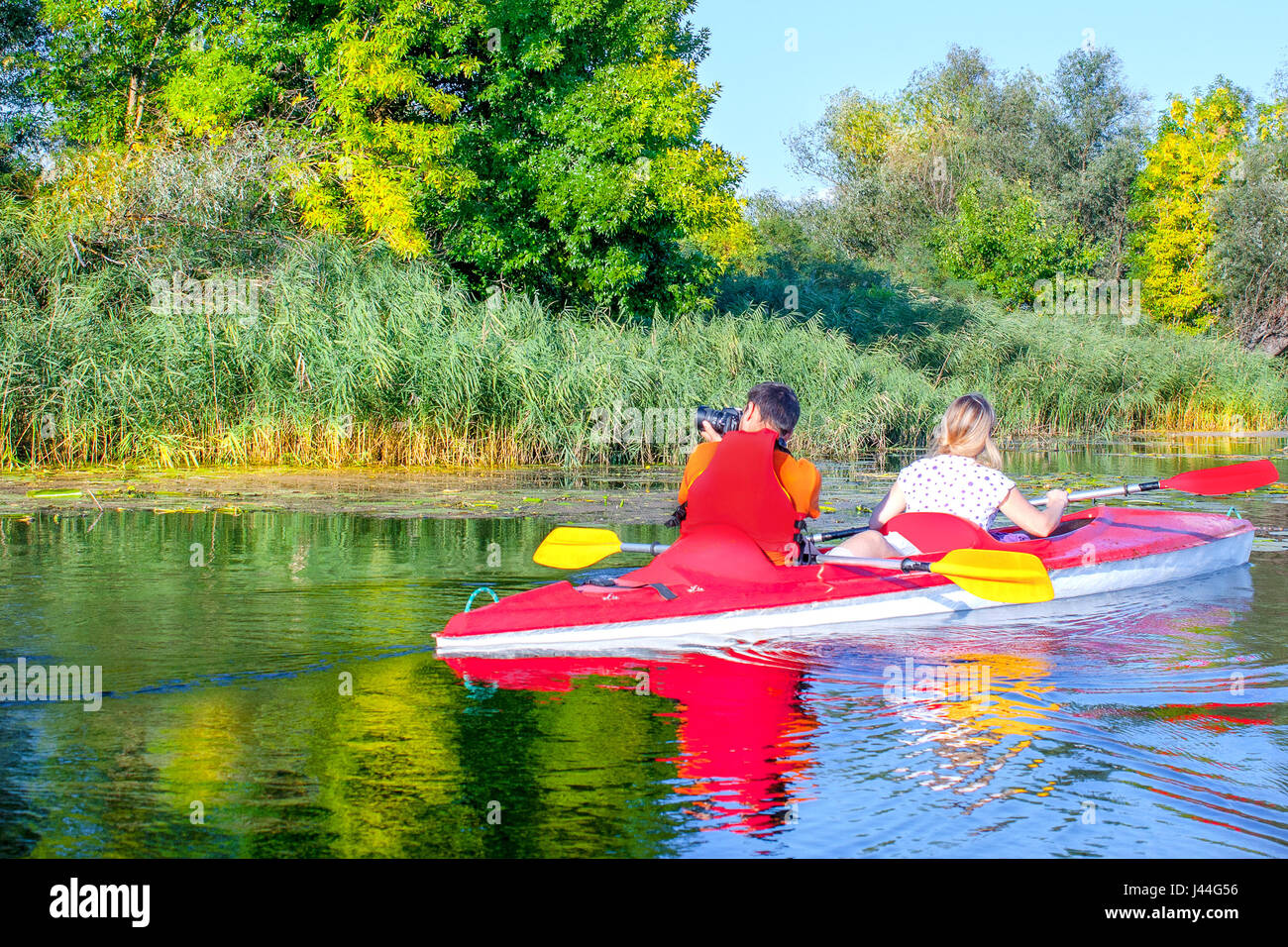 Image photographer kayak floating down the river Stock Photo - Alamy
