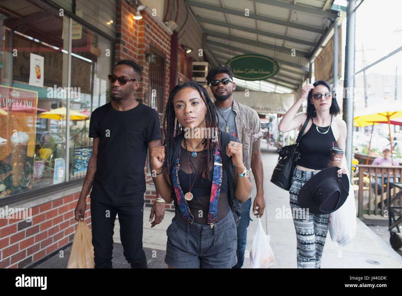 A group of friends walking down a street Stock Photo - Alamy