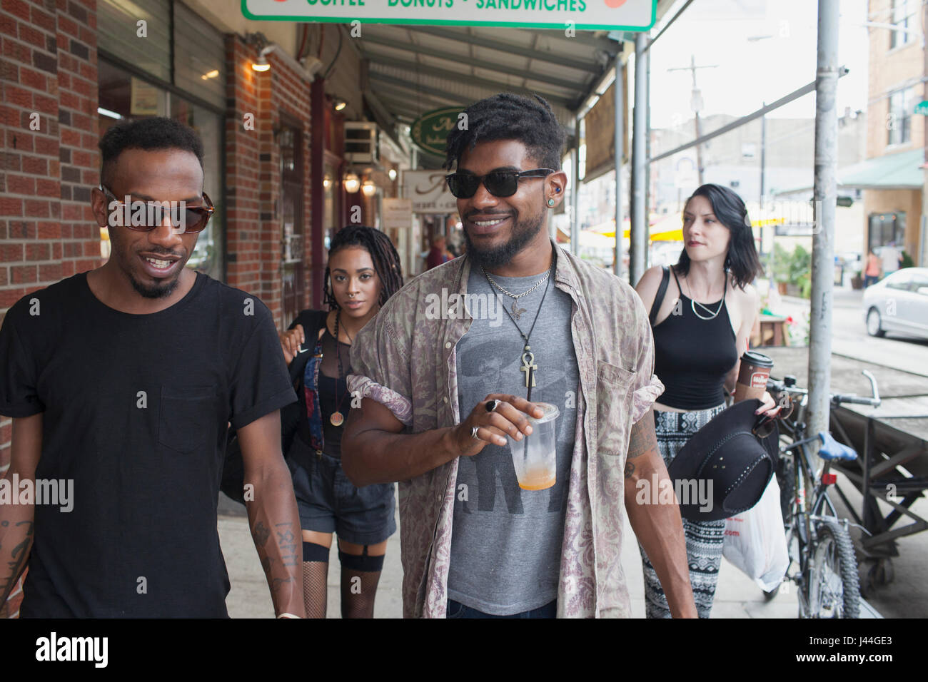 A group of friends walking down a street Stock Photo - Alamy