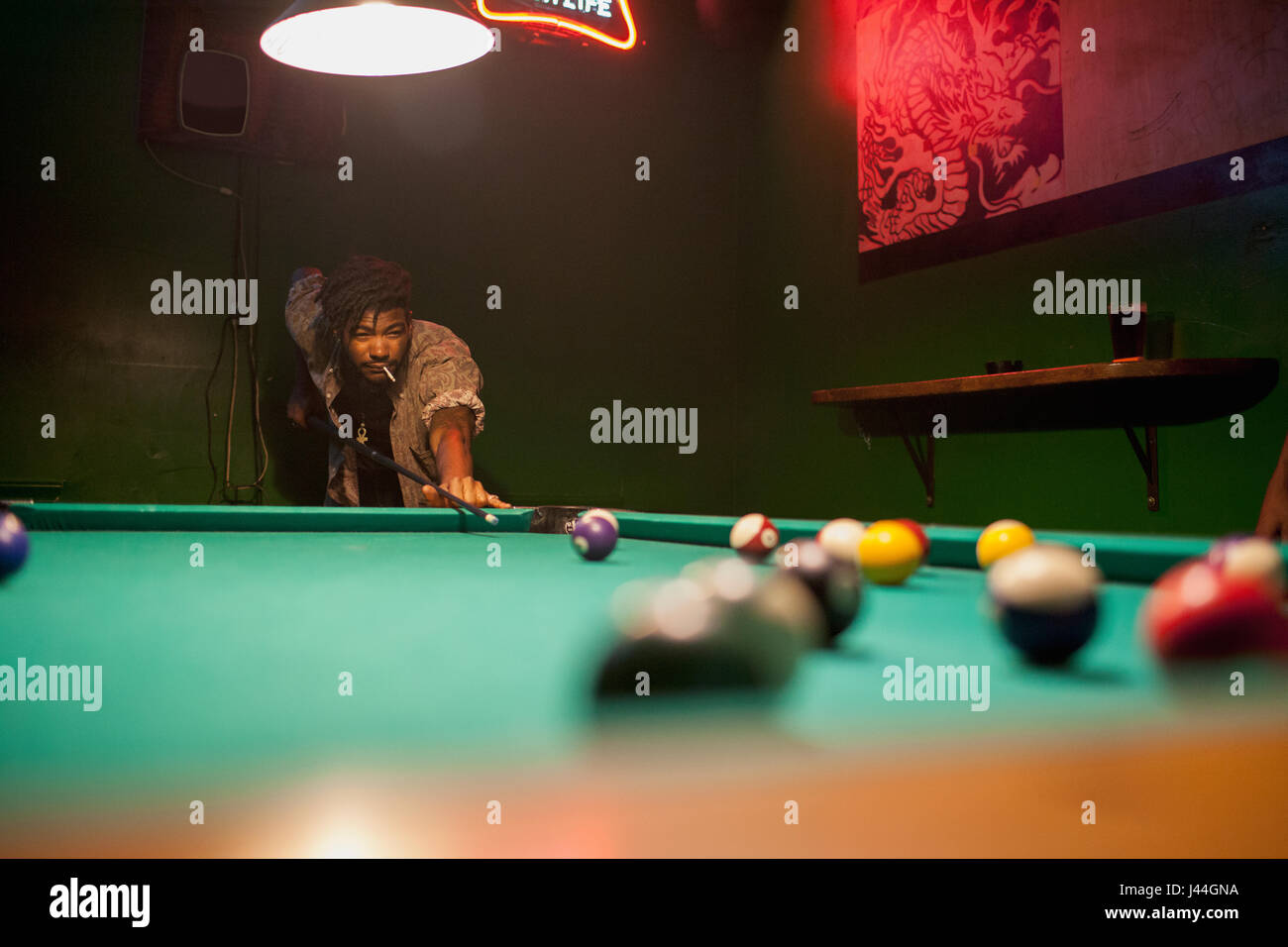 A young man playing pool Stock Photo - Alamy