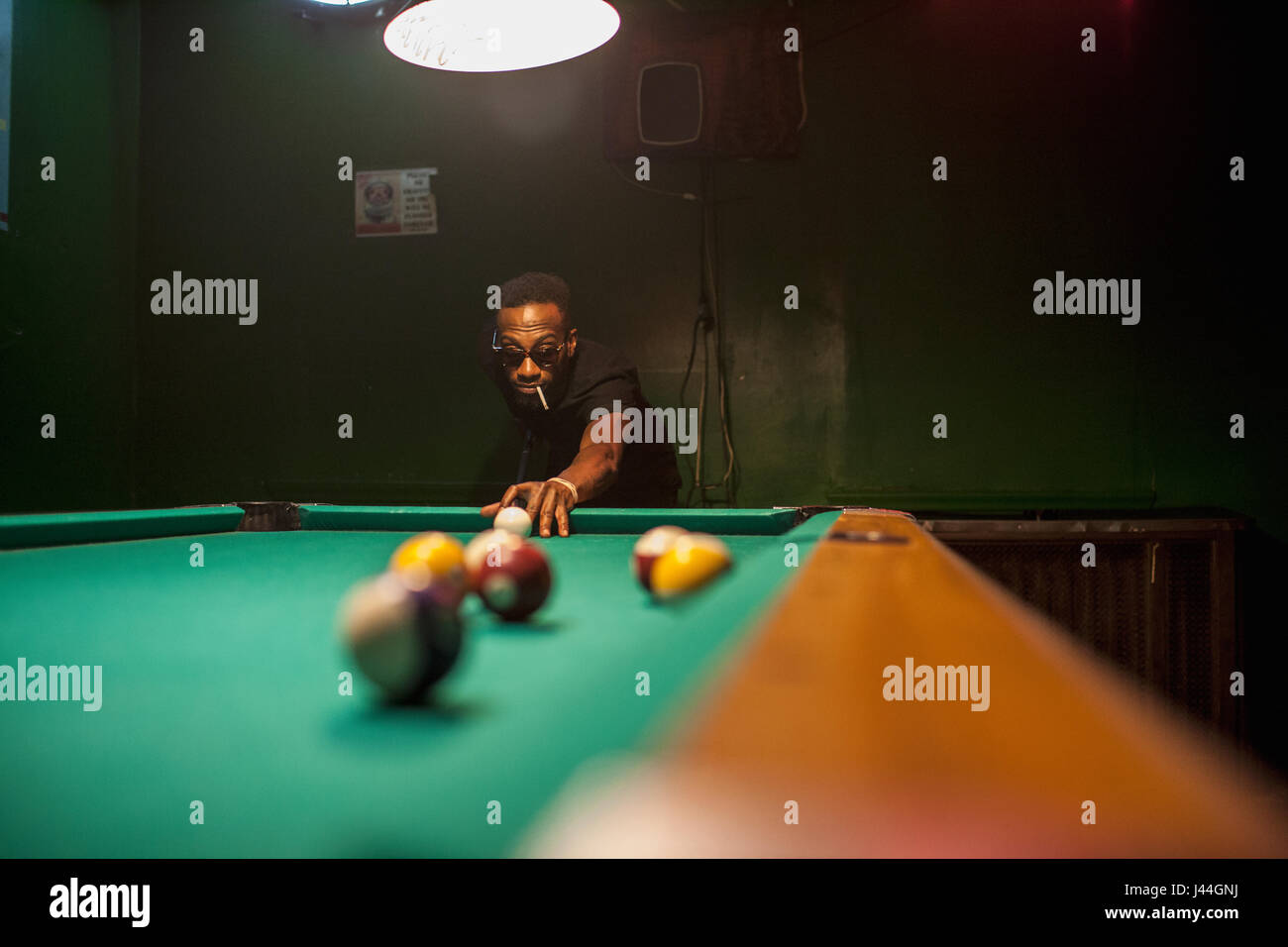 A young man playing pool Stock Photo - Alamy