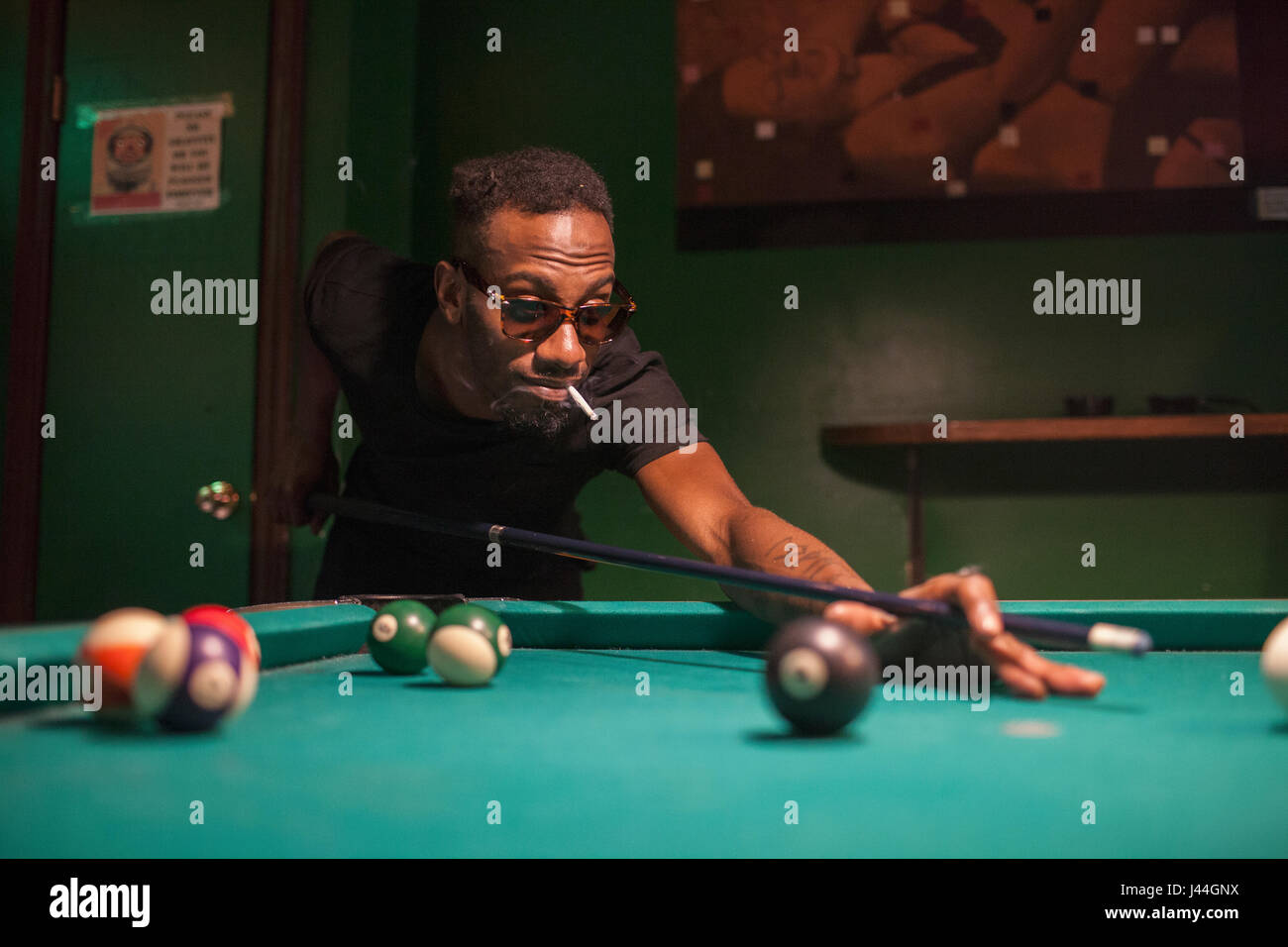 A young man playing pool Stock Photo - Alamy