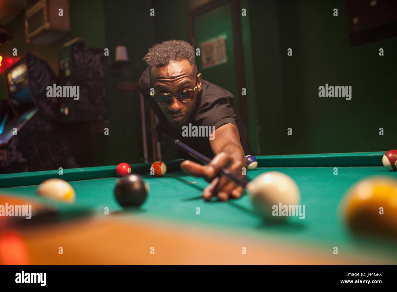 A young man playing pool Stock Photo - Alamy