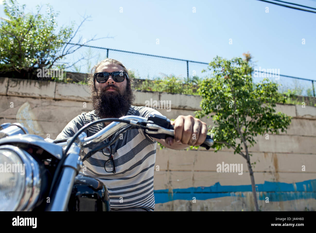A young man riding a motorcycle Stock Photo - Alamy