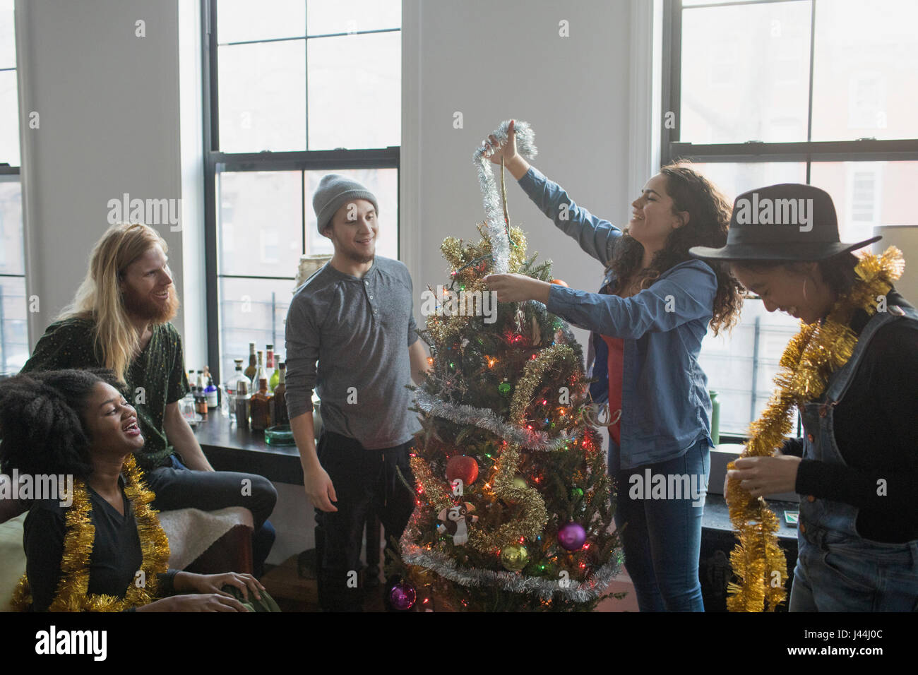 People Decorating Christmas Tree